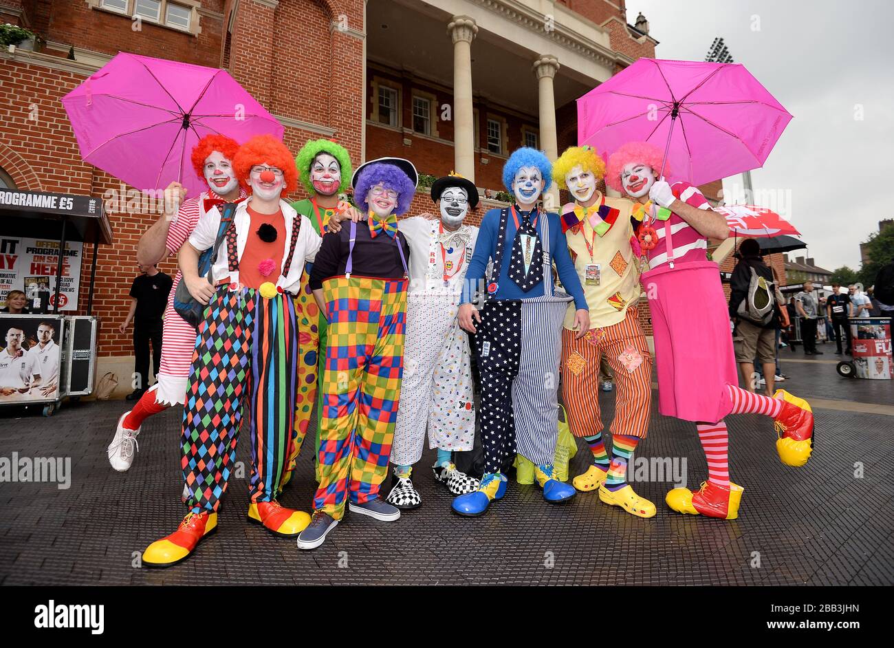 Fans dressed as clowns pose for a photograph on day four of the Fifth ...