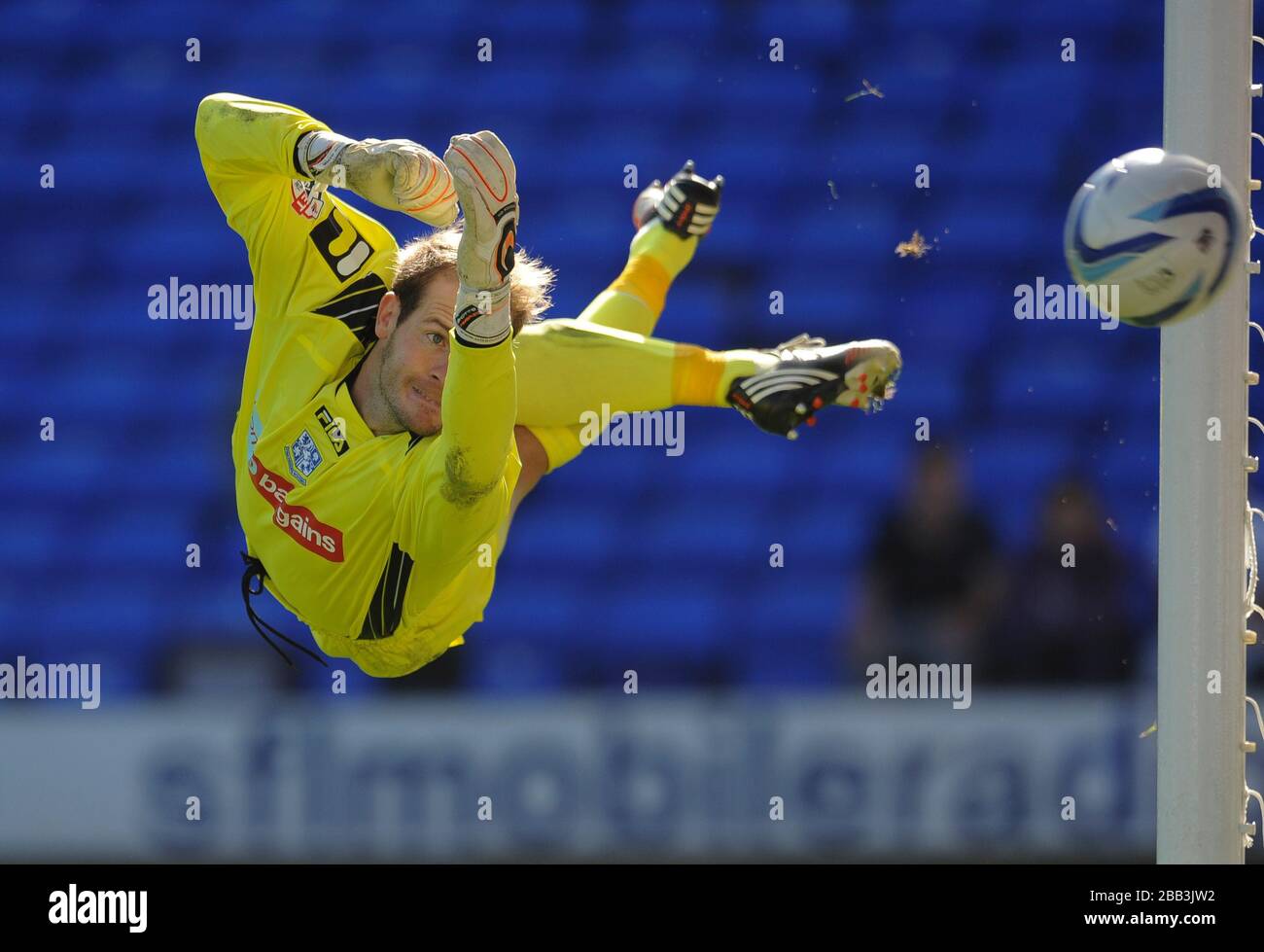 Tranmere Rovers' goalkeeper Owain Fon Williams dives to cover a shot ...