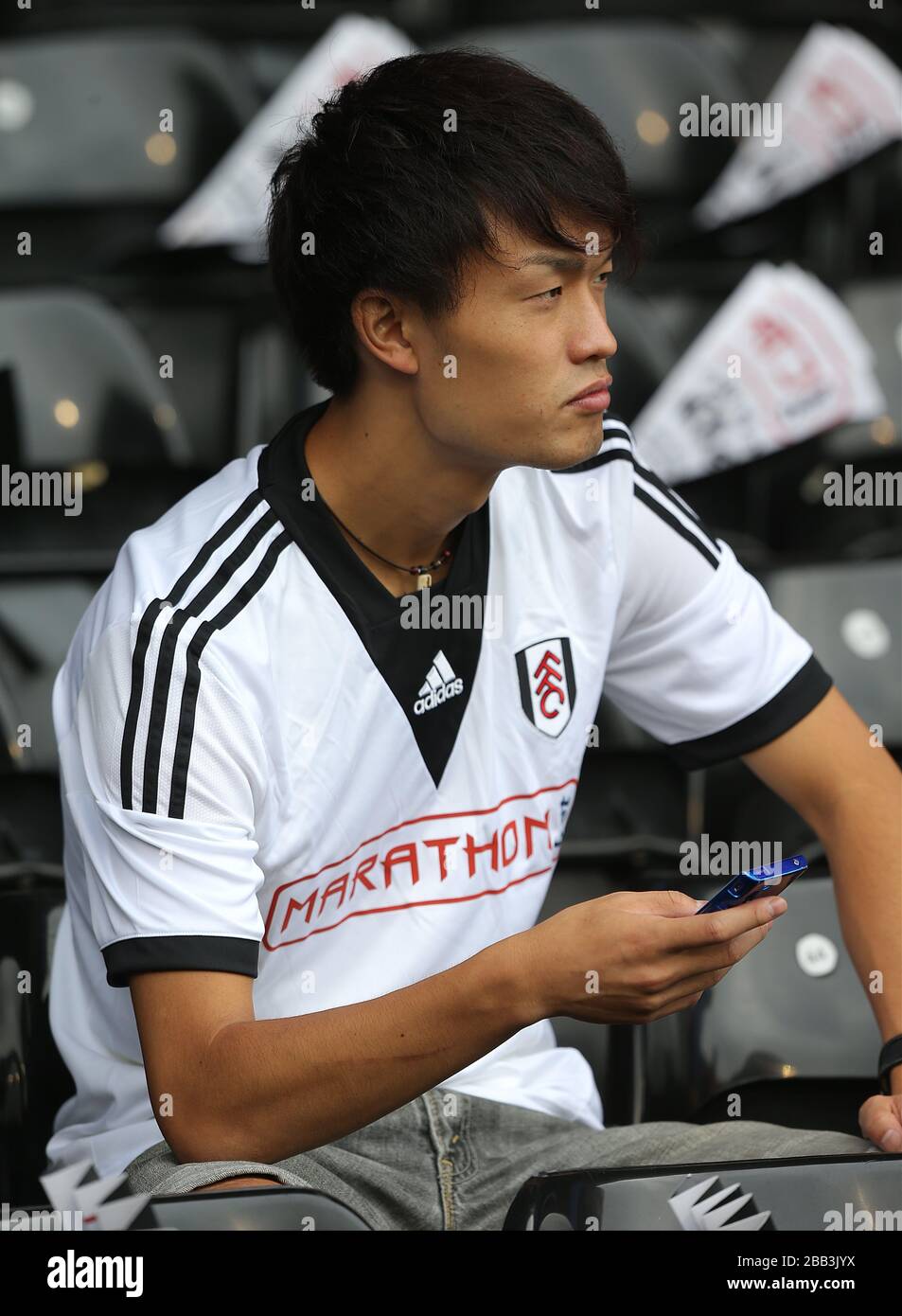A Fulham fan wearing the new adidas home kit in the stands Stock Photo ...