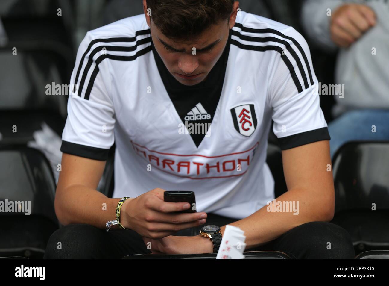 A Fulham fan wearing the new adidas home kit in the stands Stock Photo ...
