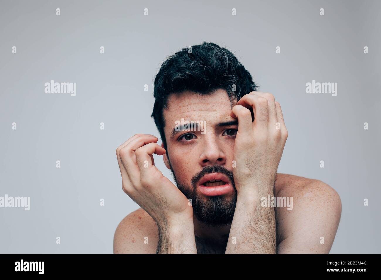 Young man isolated over background. Tired sick sad guy look on camera ...
