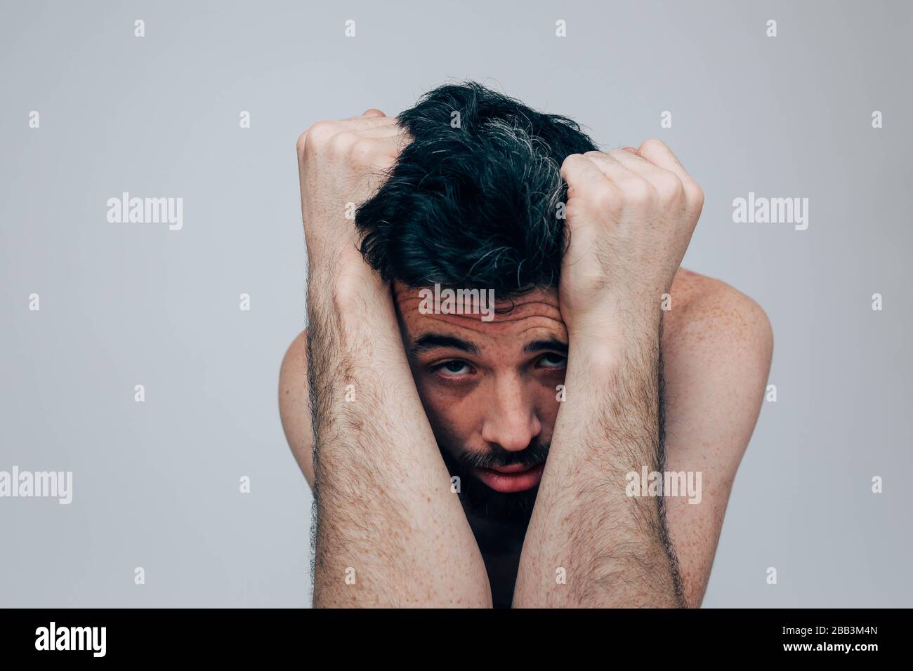 Young man isolated over background. Picture of mad guy suffer from ...