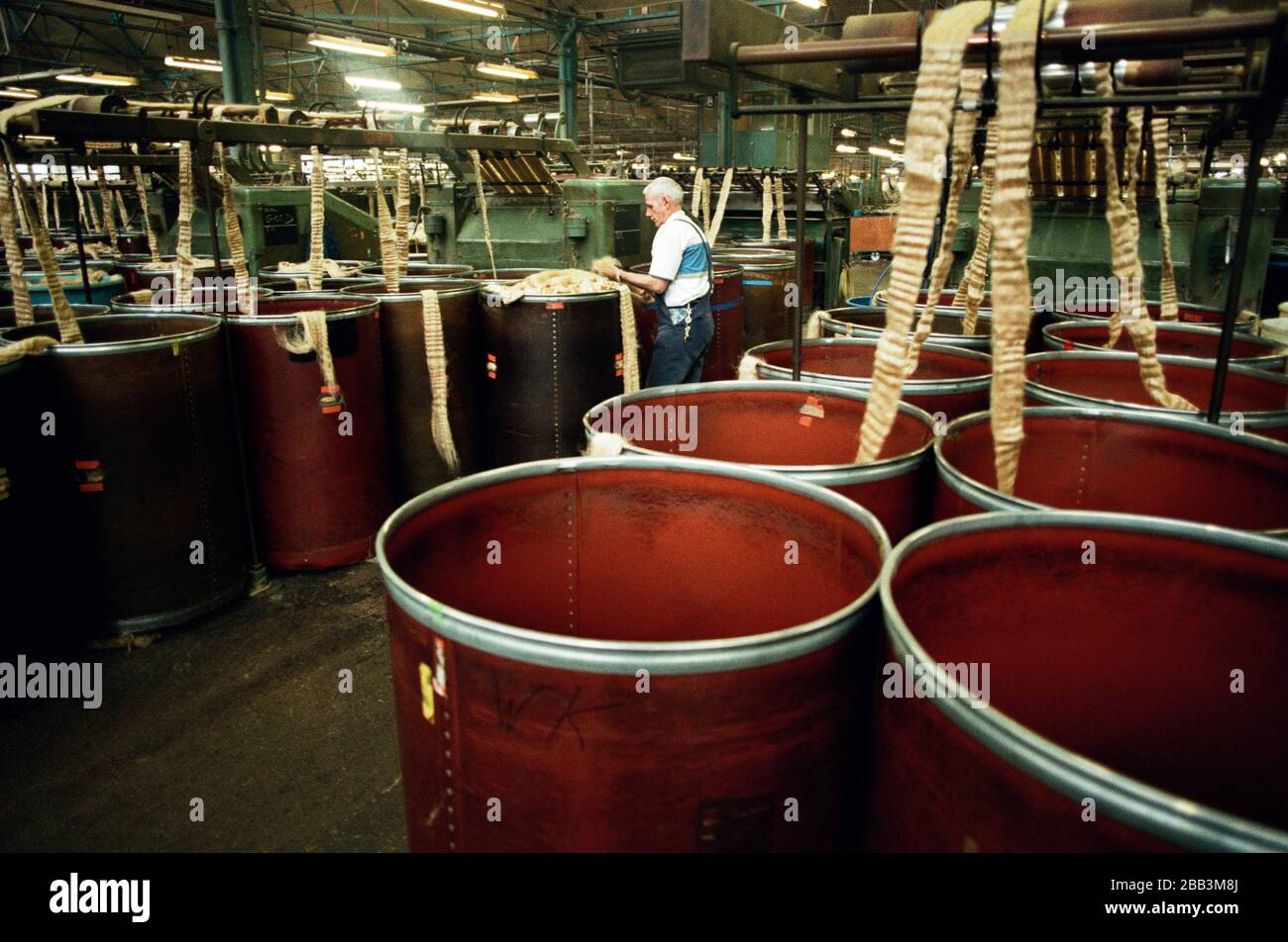 A worker supervising a machine at Tay Spinners mill in Dundee, Scotland ...