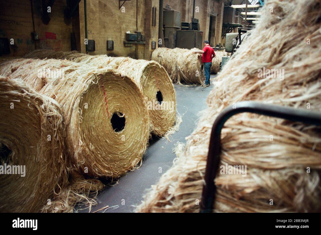A worker rolling a circular bale of jute at Tay Spinners mill in Dundee ...
