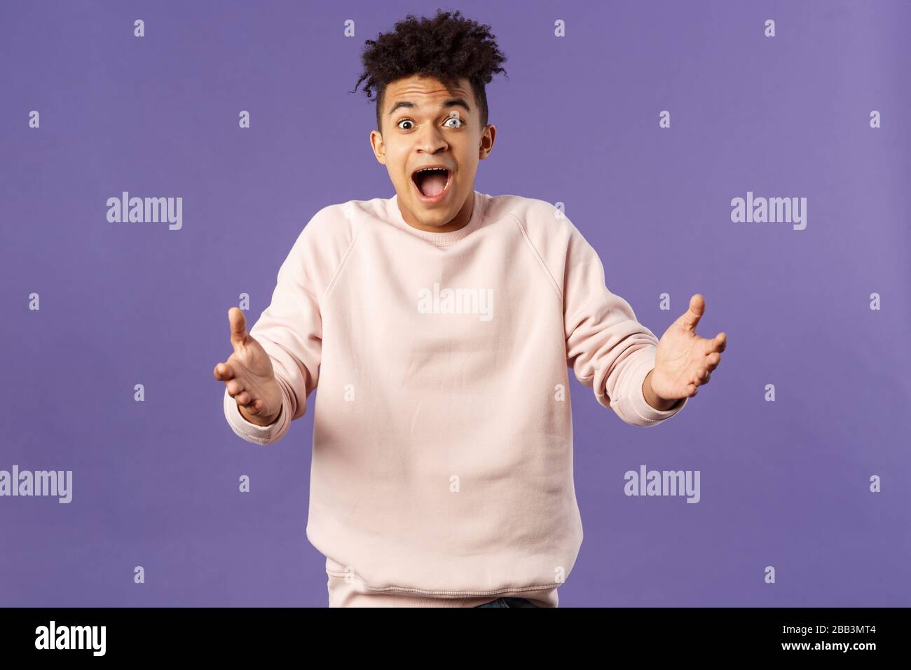 Portrait of surprised happy young man reaching hands to hug friend ...