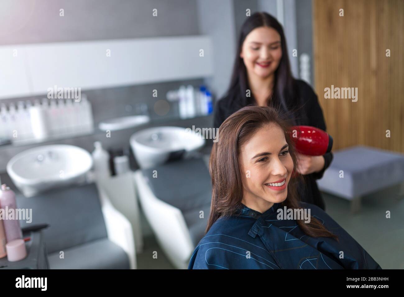Hairdresser and client at hair salon Stock Photo - Alamy