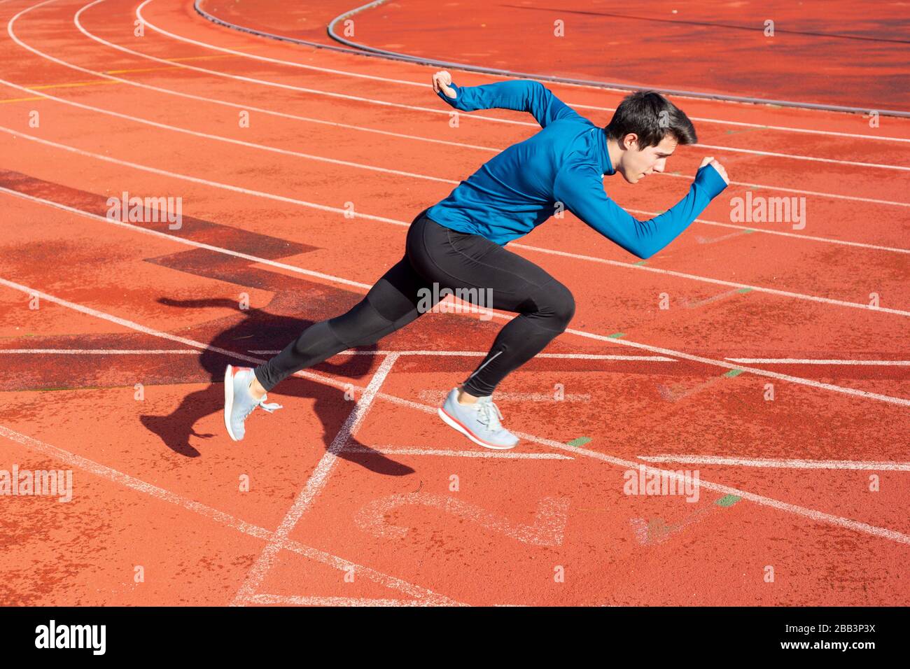 Runner starting his sprint on running track in a stadium Stock Photo ...