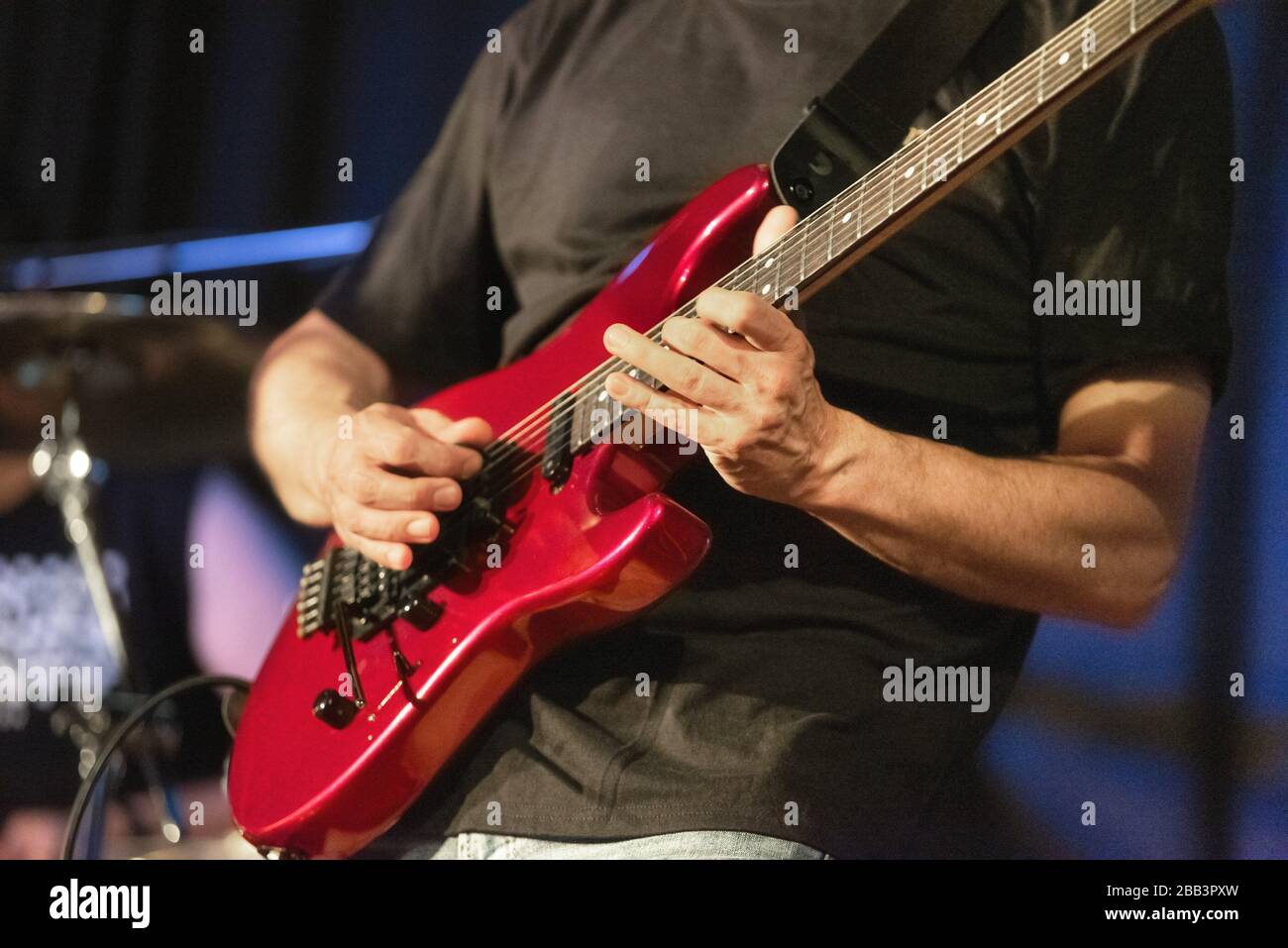 Man lead guitarist playing electrical guitar on concert stage Stock ...