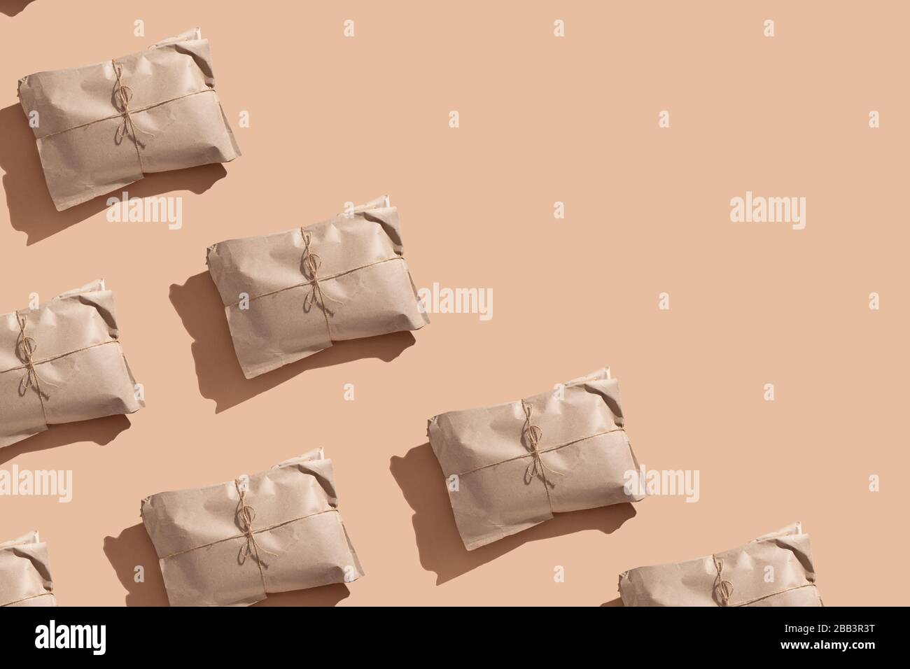 The parcel is wrapped with kraft paper and tied with a rope. Modern ...