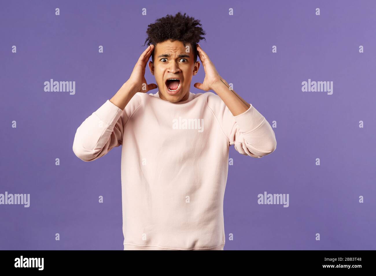 Portrait of scared and anxious young hispanic handsome man in panic ...