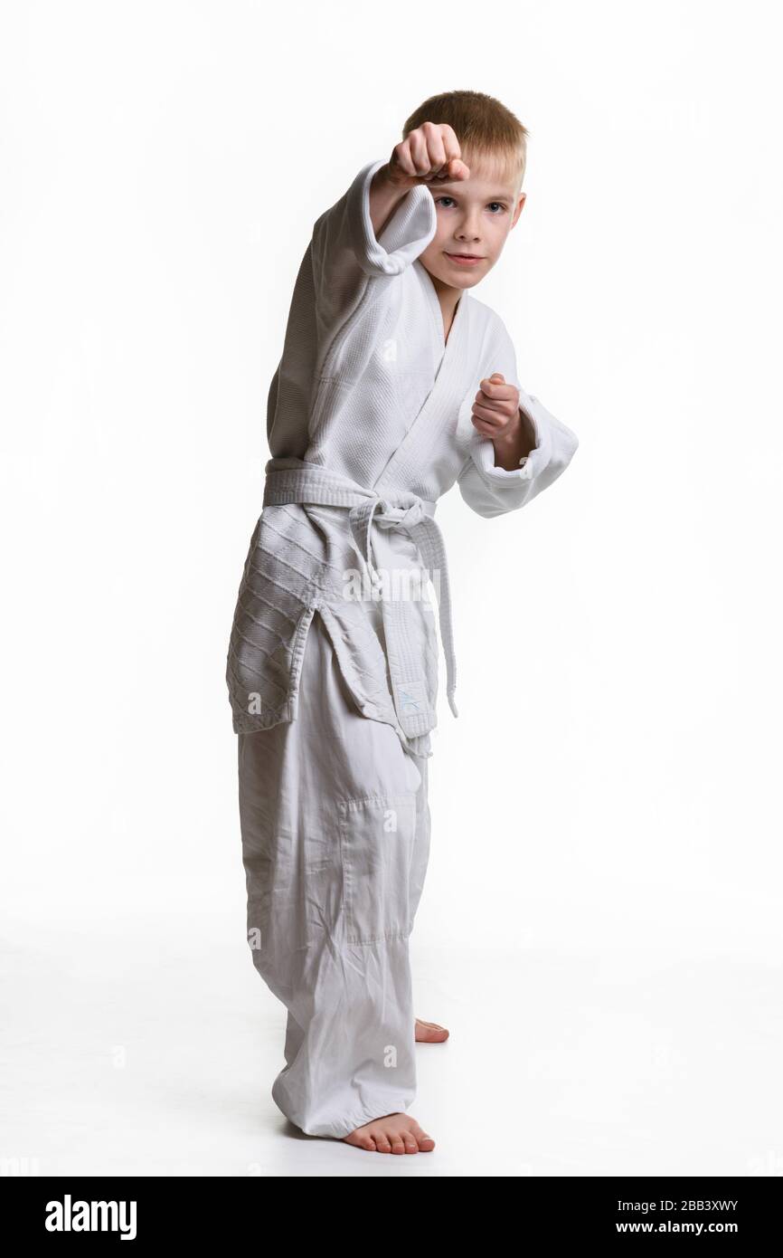Karate boy hits with his right hand, white background Stock Photo - Alamy
