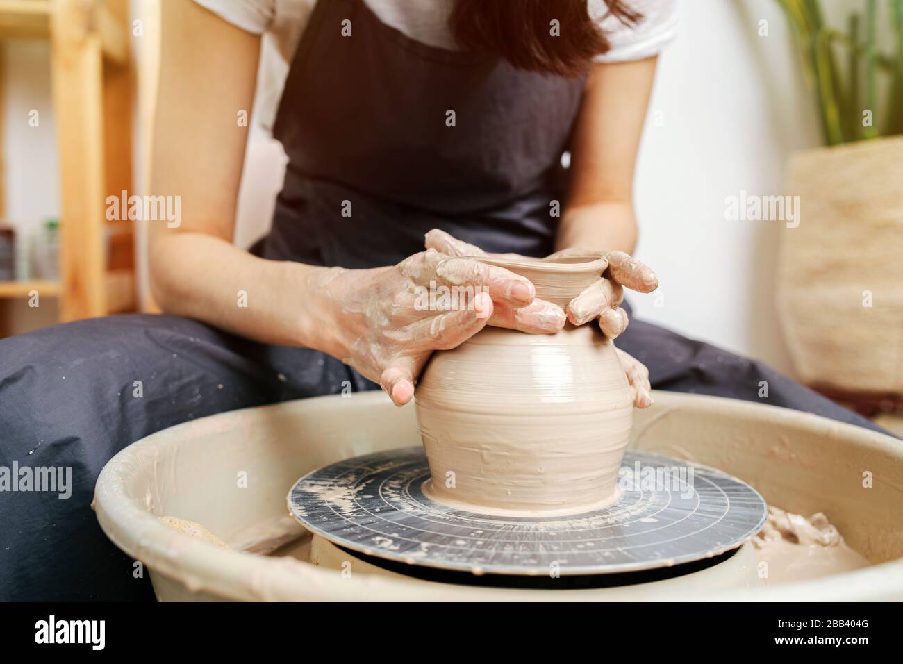 The pot is formed from clay mass, close-up female hands at work Stock ...