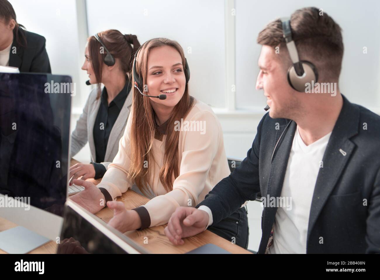 young call center colleagues looking at each other Stock Photo - Alamy