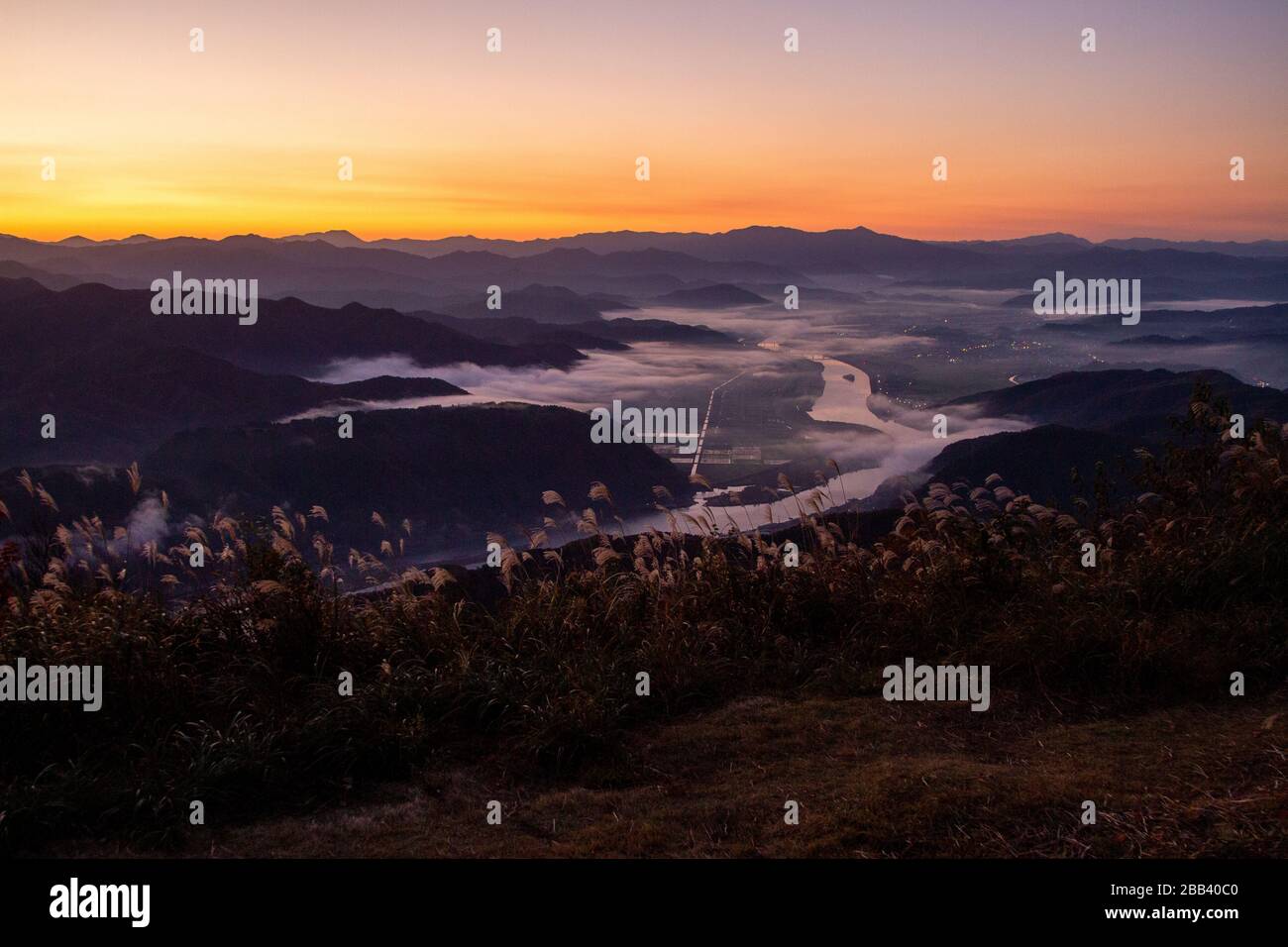 Misty morning sunrise over the bay and city of Toyooka (Toyooka-shi) is ...
