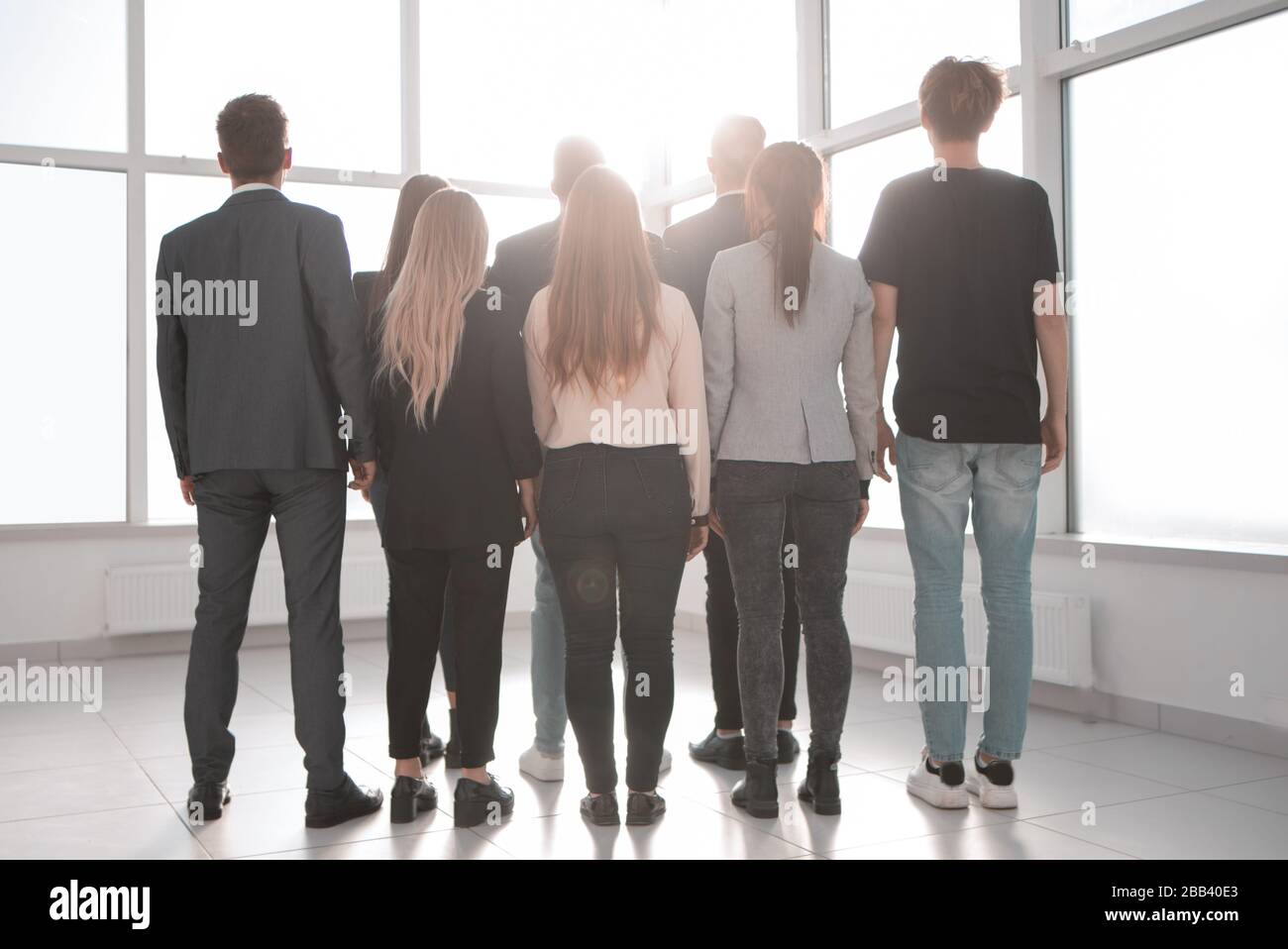 rear view. a group of diverse young business people standing together ...