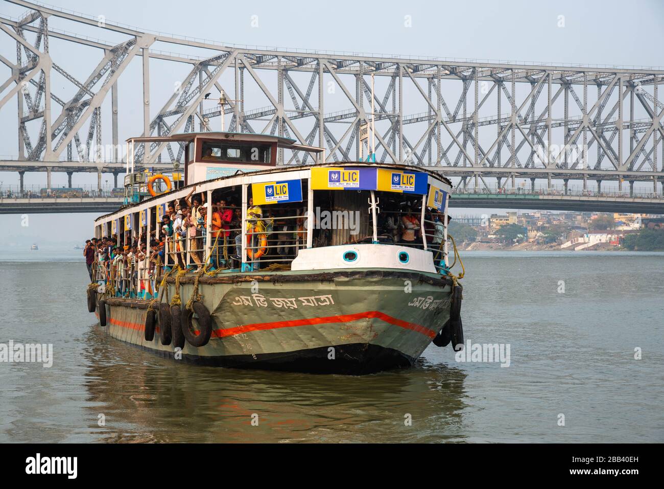 view at Howrah bridge with ferry at Hooghly river in Calcutta, India ...