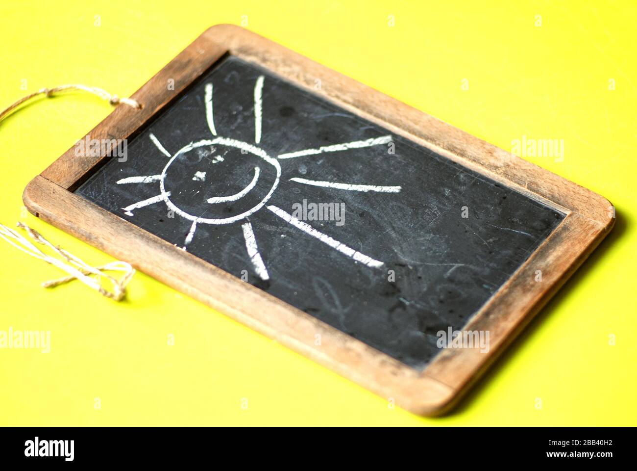 Chalkboard with a smiling sun drawing Stock Photo - Alamy