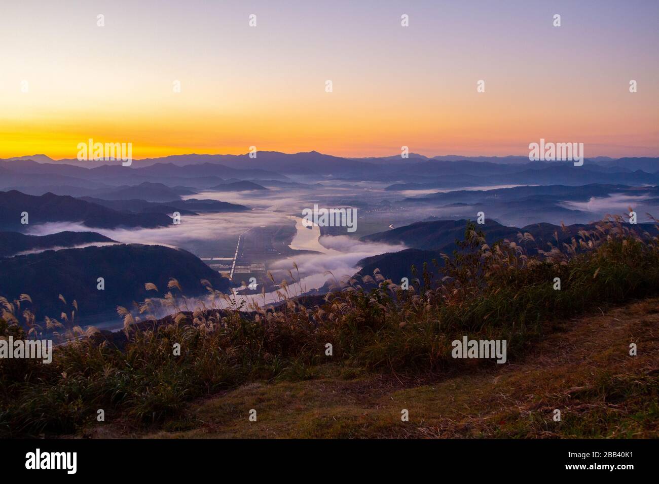 Misty morning sunrise over the bay and city of Toyooka (Toyooka-shi) is ...