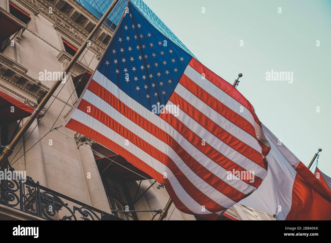 USA Flag Draping From Building In New York Stock Photo - Alamy