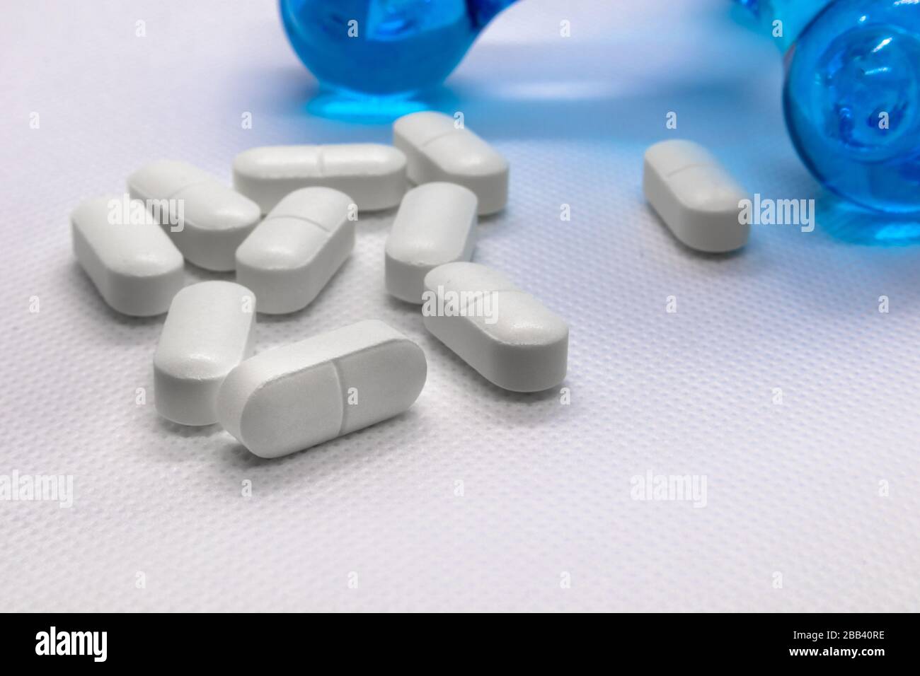 White long pills on white background. Cure medicine health drug light ...