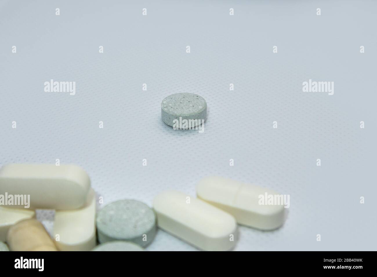 Colored mint white brown supplements health drug pills on white ...