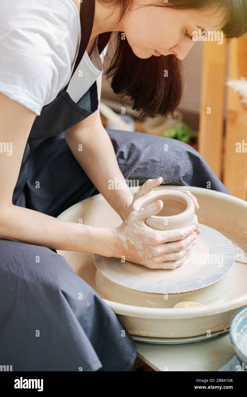 Close up sad woman distracted from problems engaged in pottery at home ...