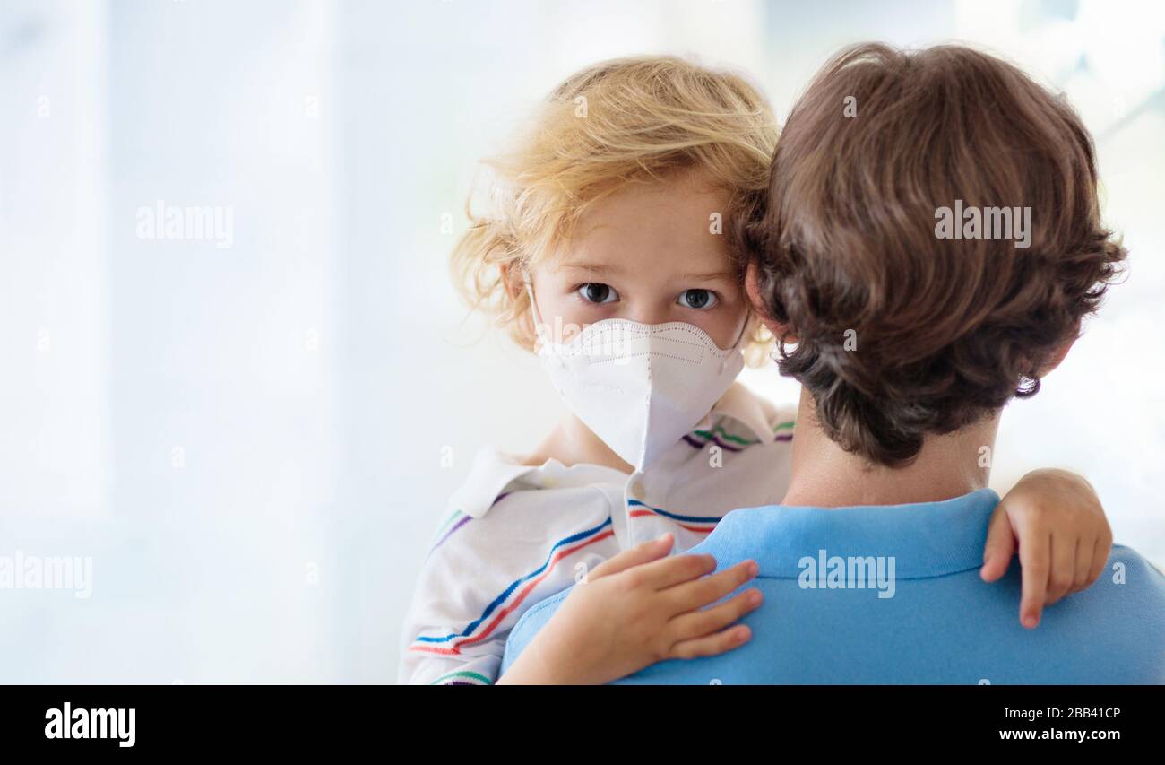 Family with kids in face mask in shopping mall or airport. Father and ...