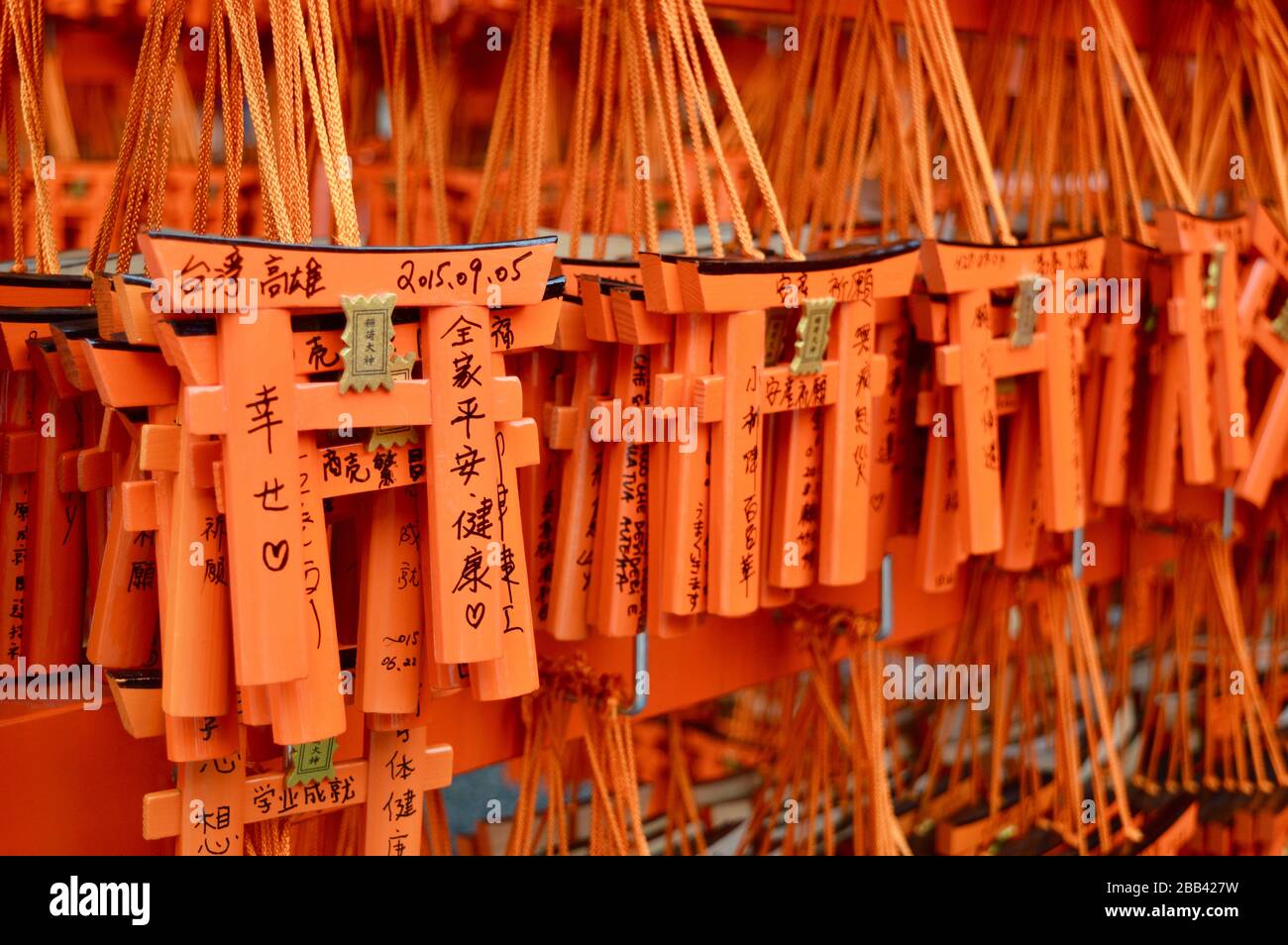 Whishes on small torii's in a temple in Japan Stock Photo - Alamy
