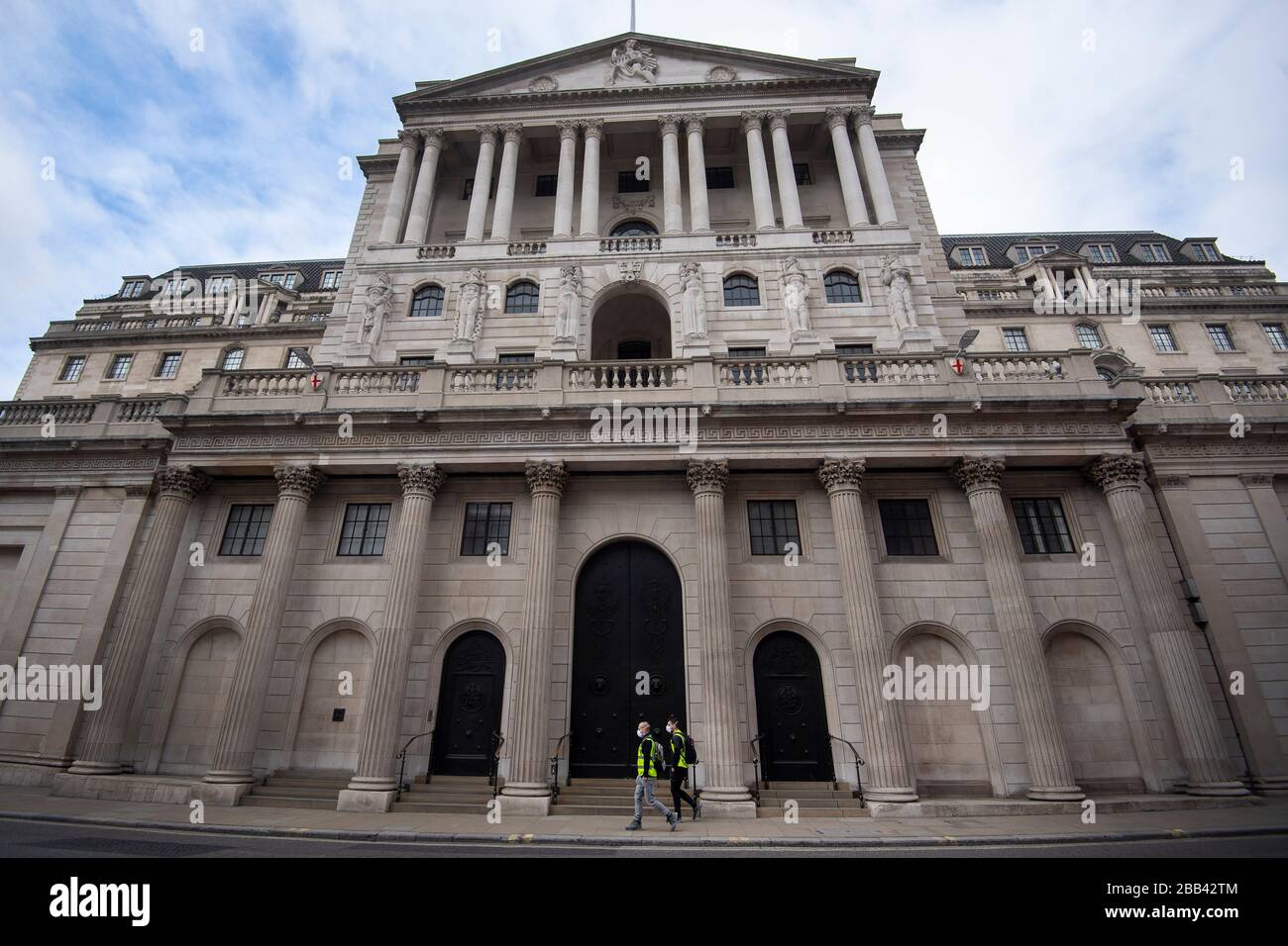 Face masks walk past bank england hi-res stock photography and images ...