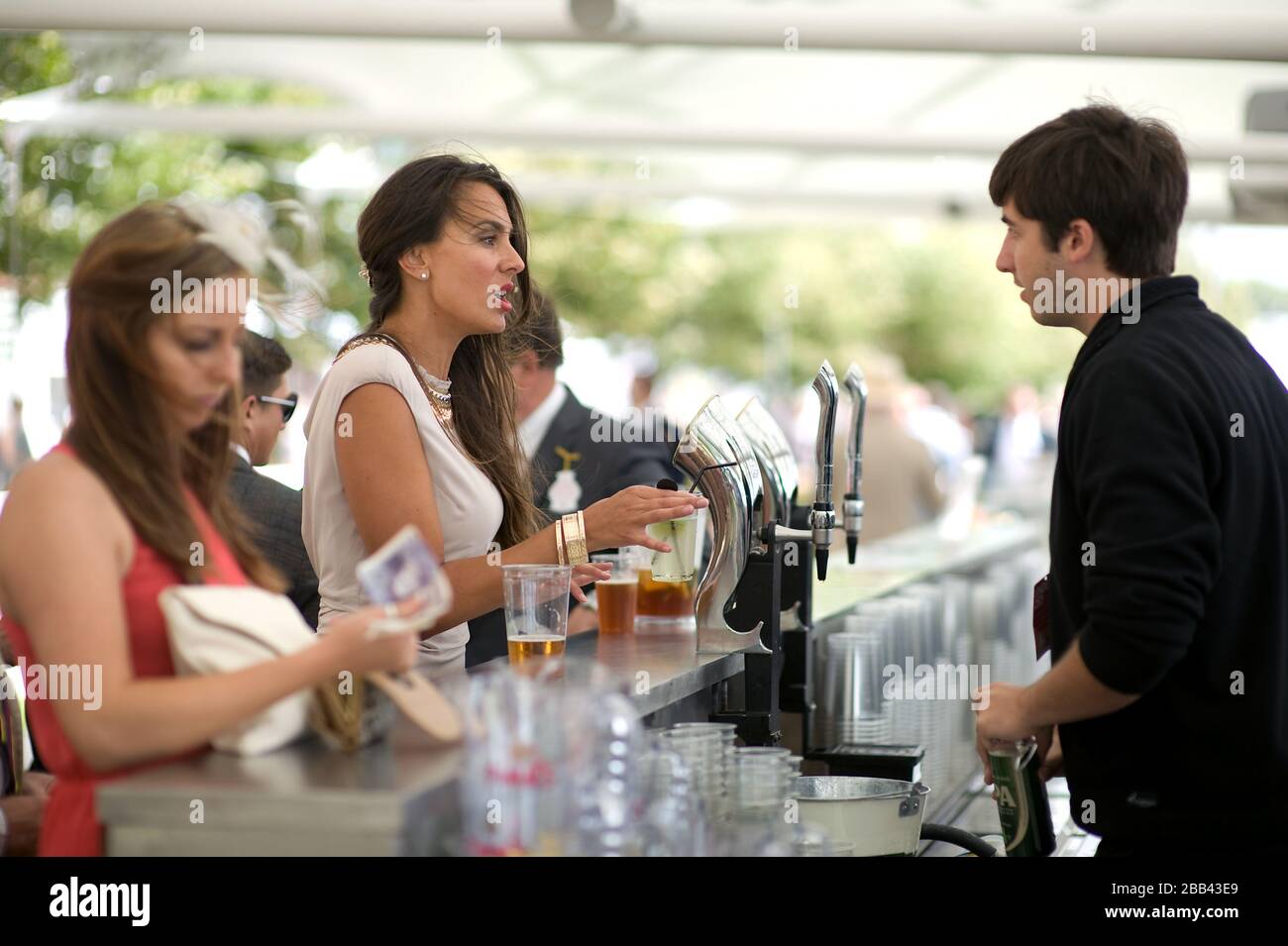 Racegoers in a bar at Goodwood Races Stock Photo - Alamy