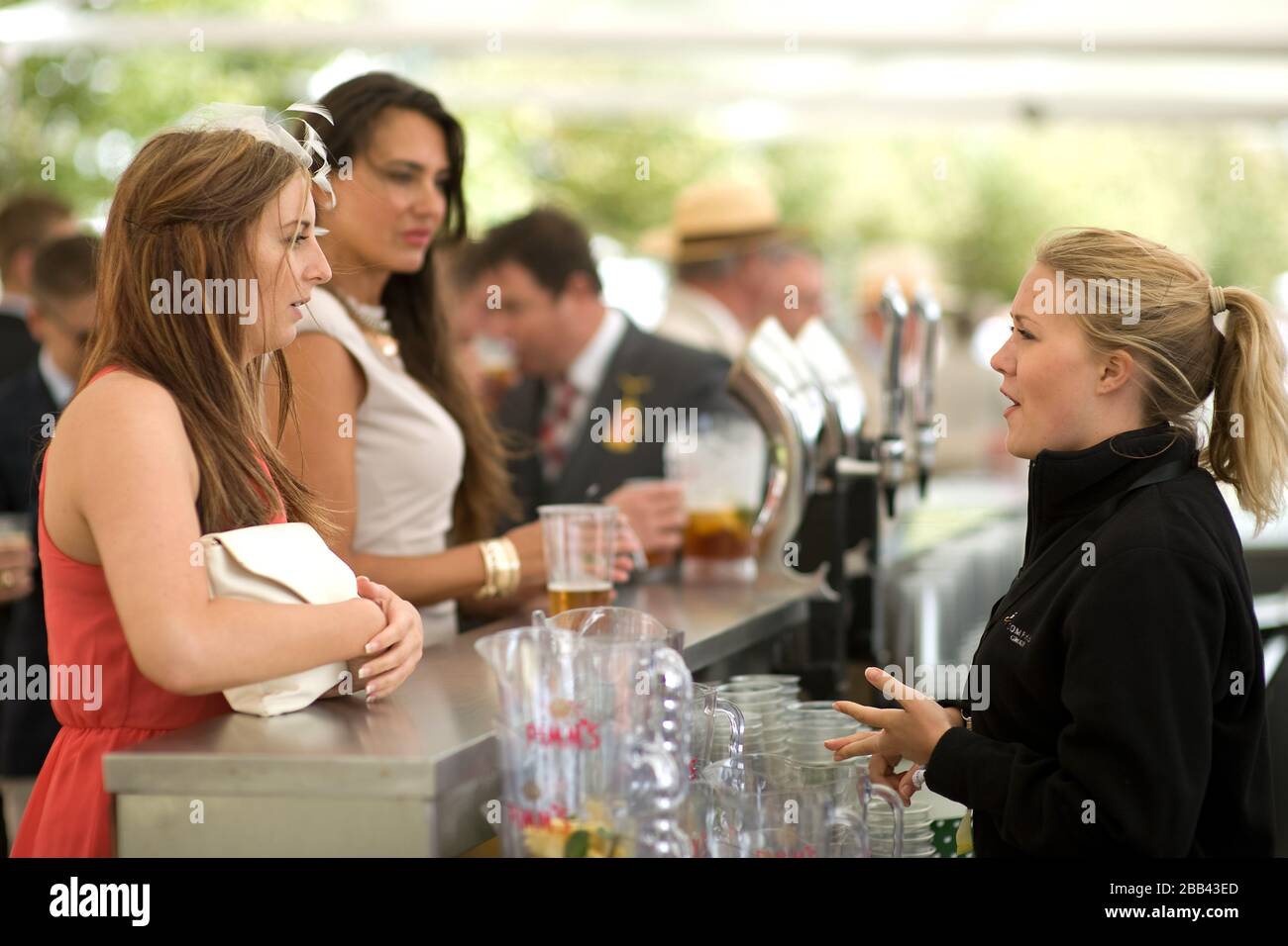 Racegoers in a bar at Goodwood Races Stock Photo - Alamy