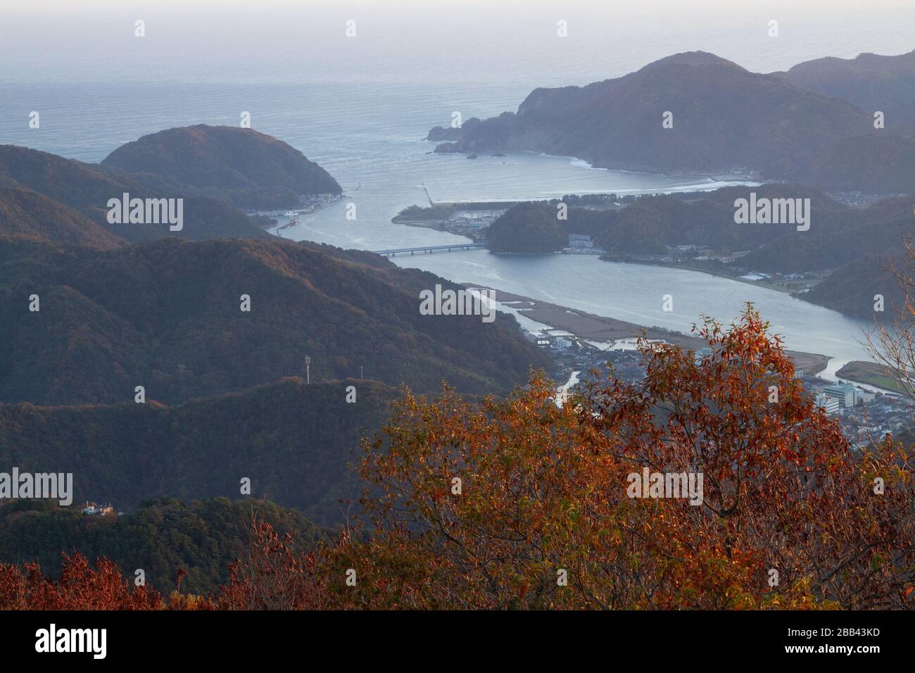 Misty morning sunrise over the bay and city of Toyooka (Toyooka-shi) is ...