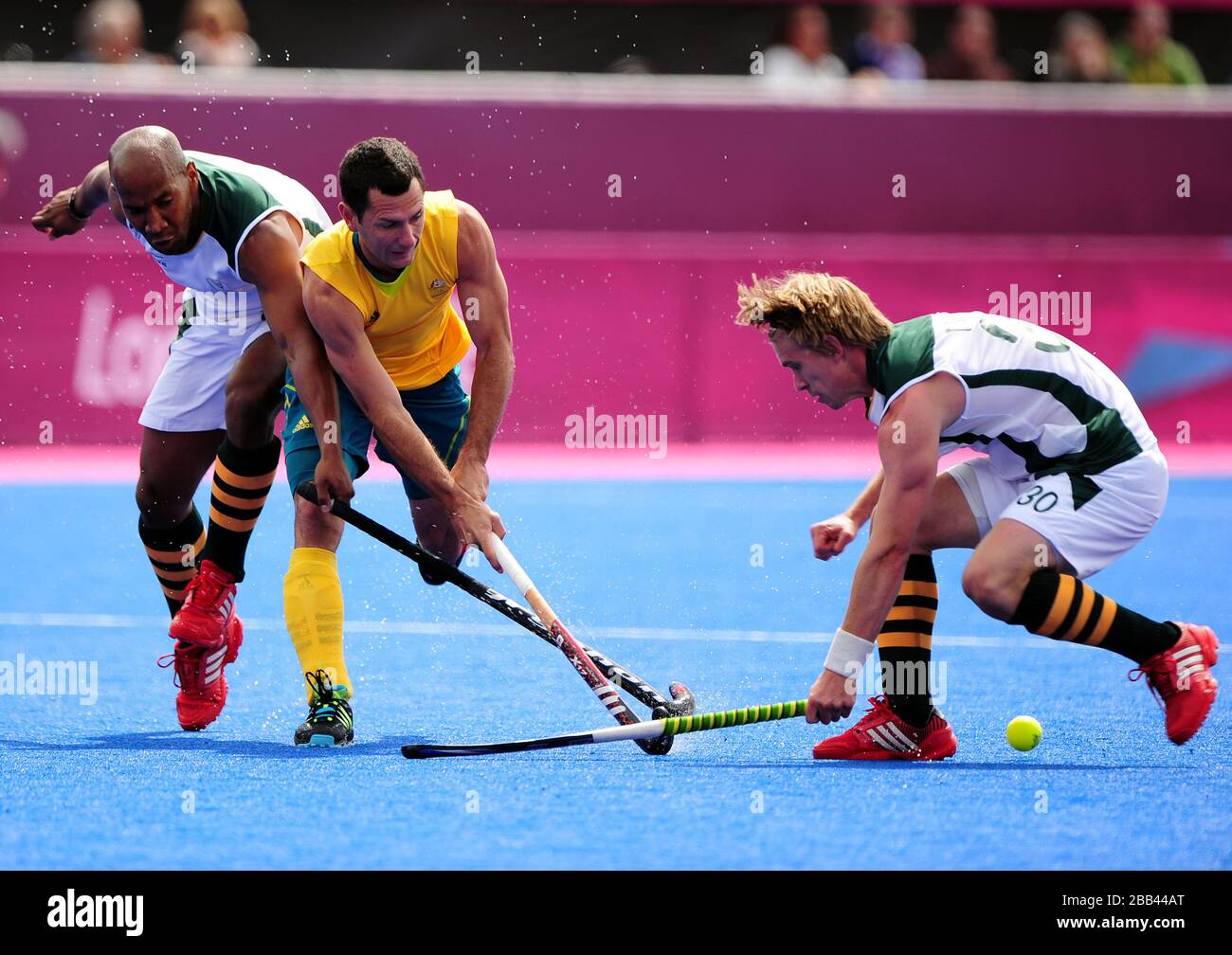 Australia's Jamie Dwyer (centre) is stopped by South Africa's Julian ...