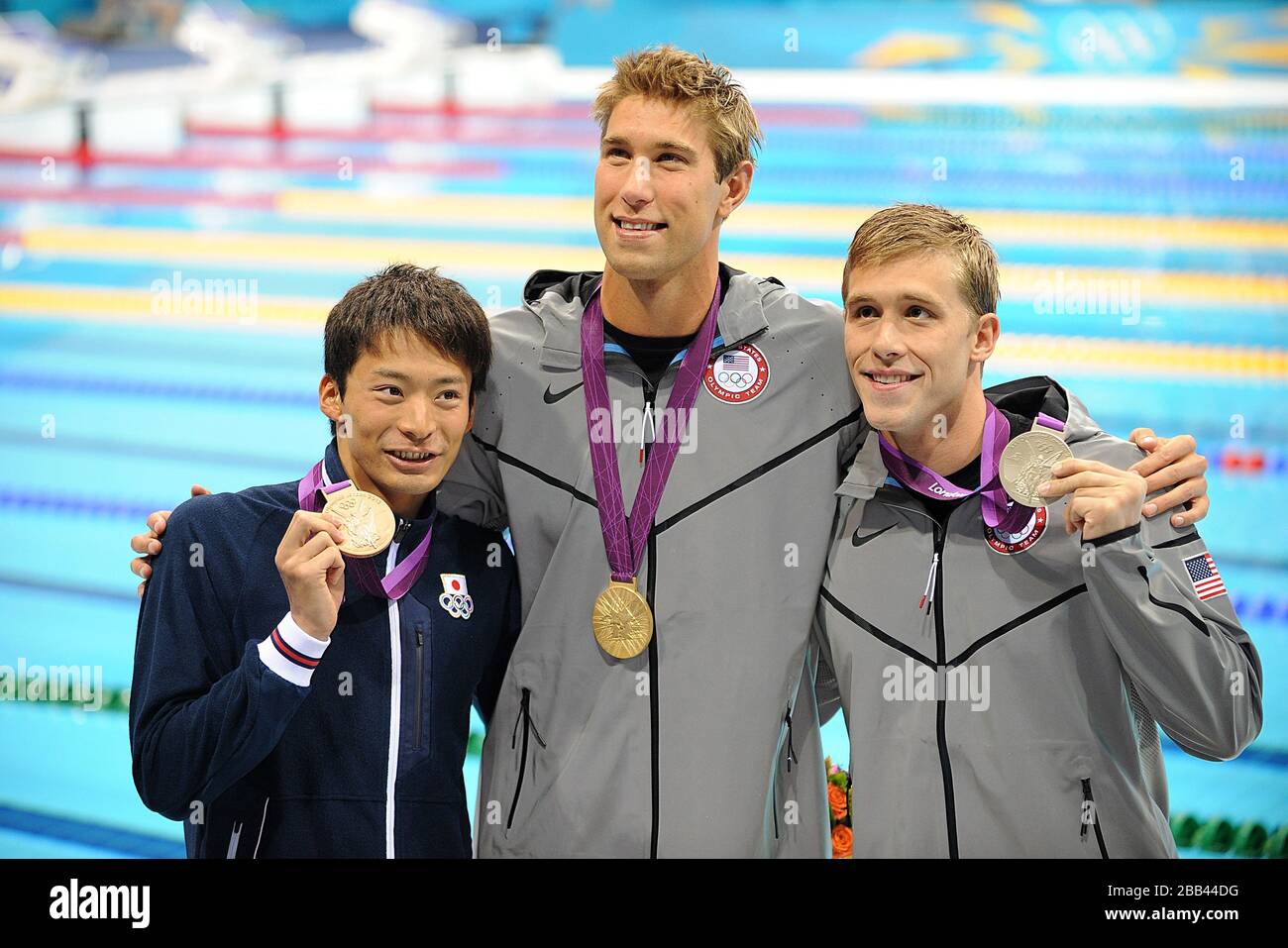 USA's Matthew Grevers (centre) on the podium with his gold medal ...