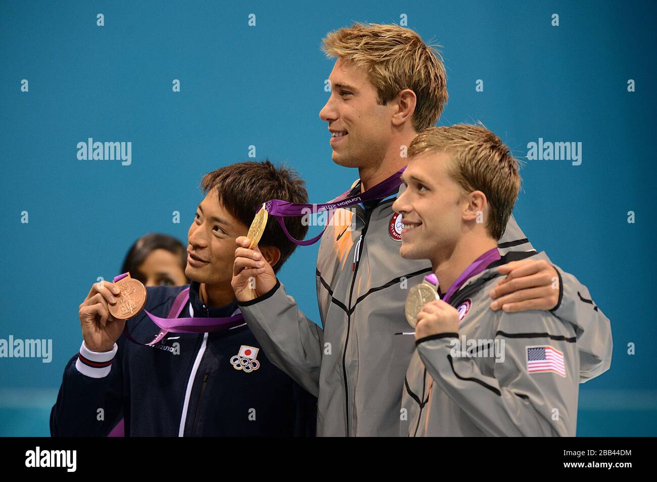 USA's Matthew Grevers (centre) on the podium with his gold medal ...