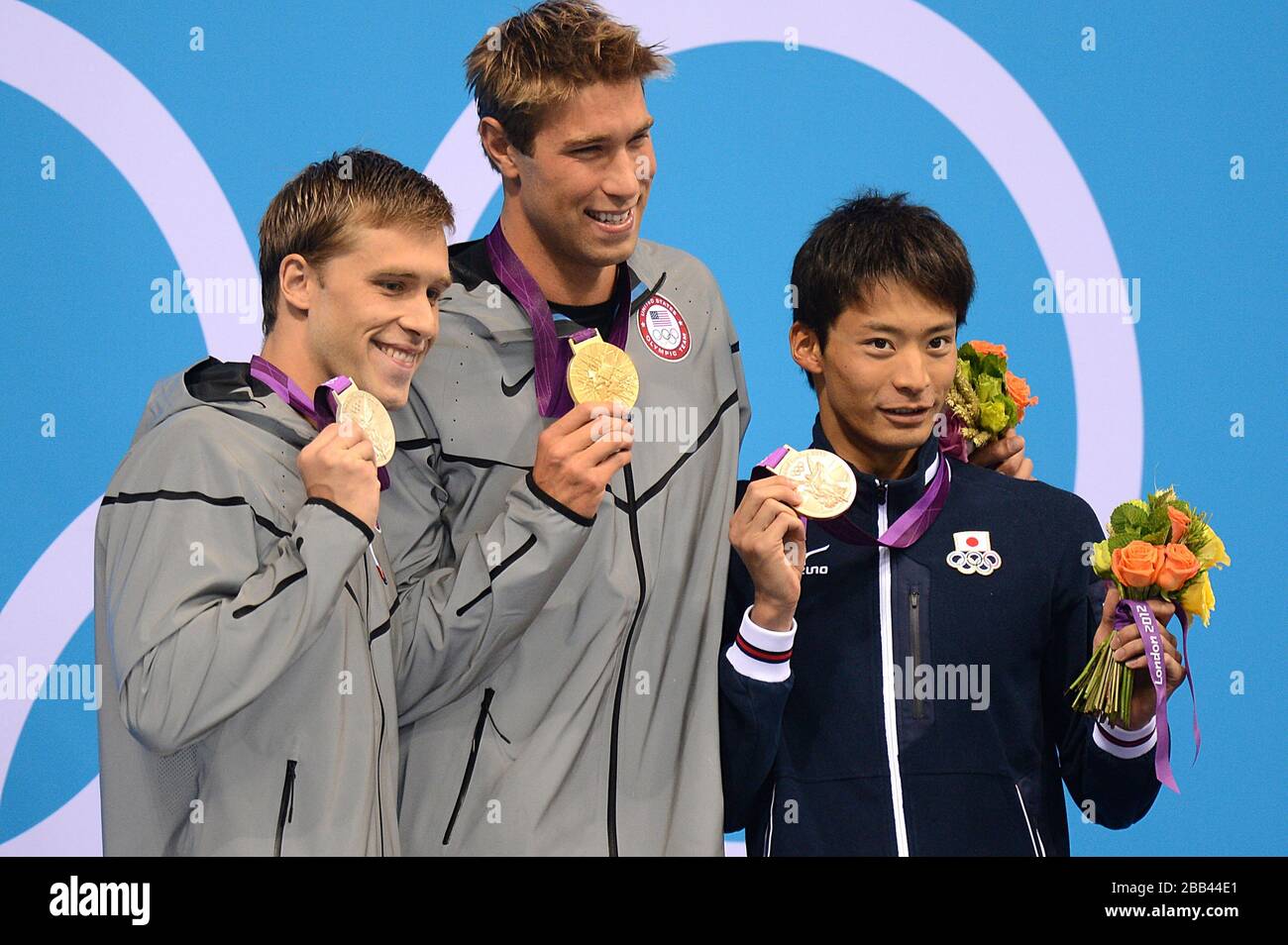 USA's Matthew Grevers (centre) on the podium with his gold medal ...