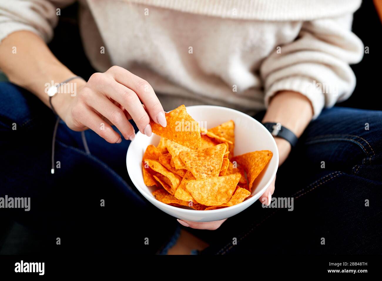 A close up of a caucasian female hands holding a white bowl containing ...
