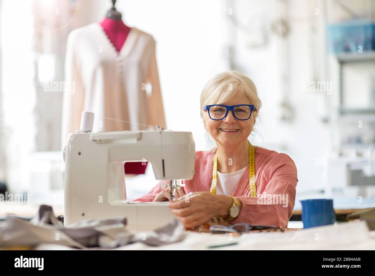 Confident senior fashion designer in her workshop Stock Photo - Alamy