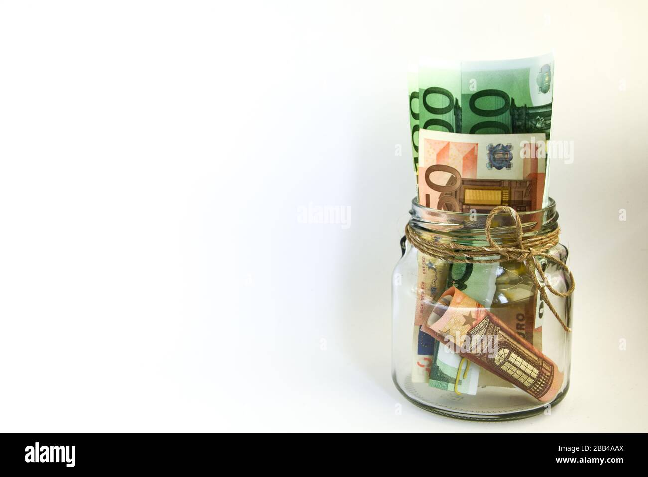Glass jars filled with coins and Euro bills, savings inside glass jar ...