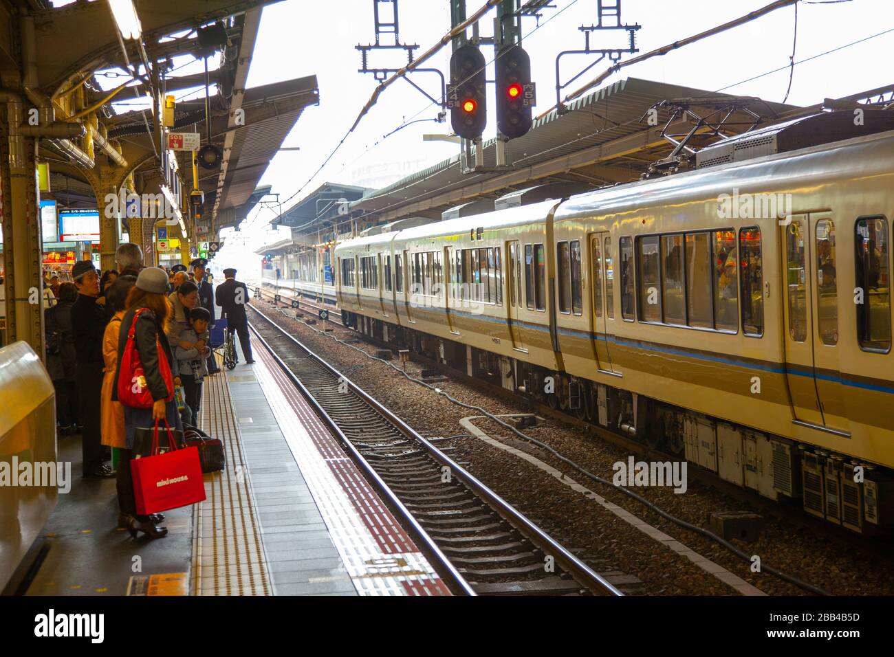 Commuters on the platform at Osaka train station, Osaka Japan Stock ...