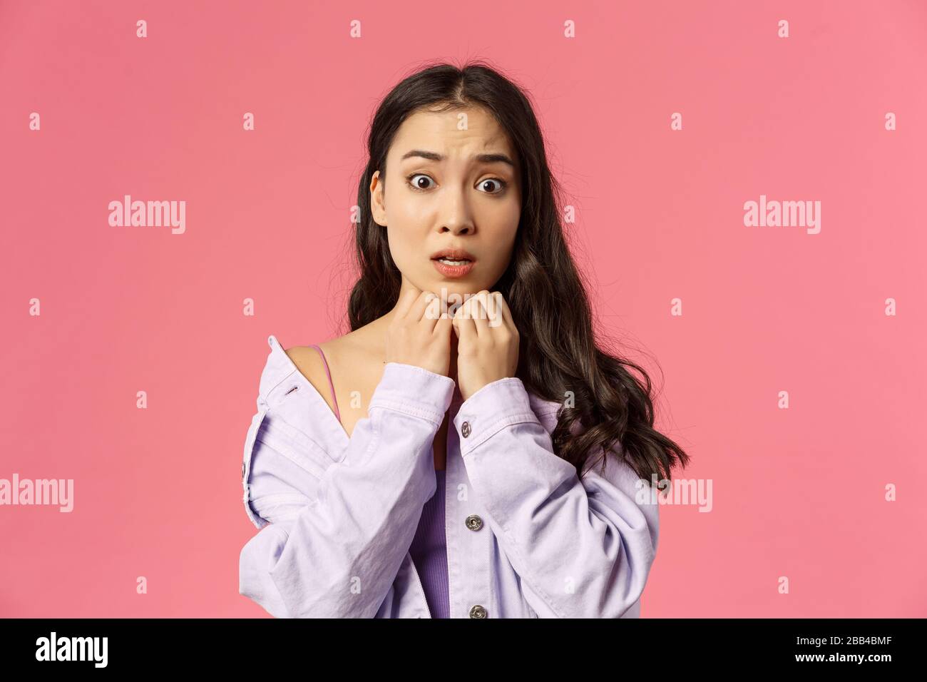 Close-up portrait of timid frightened asian girl feeling unsafe, hold ...