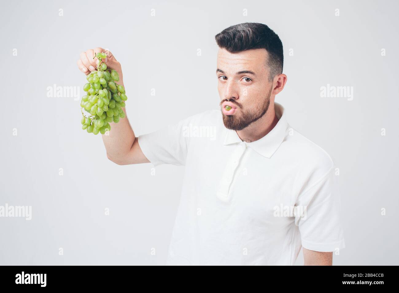 man holding grape, close up. concept. isolated on white Stock Photo - Alamy