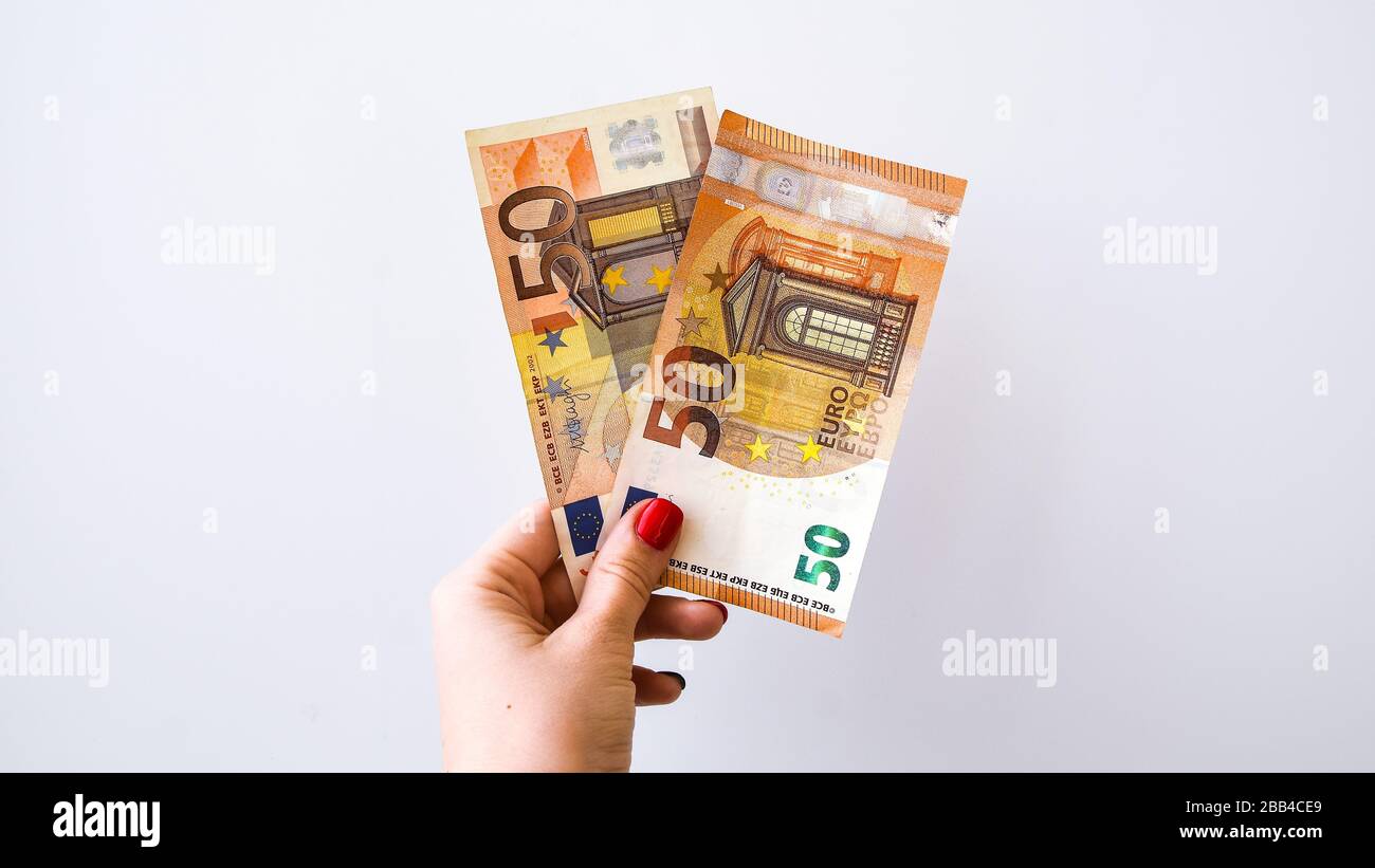 Woman's hand with 50 euros money on a white background, copy space for ...