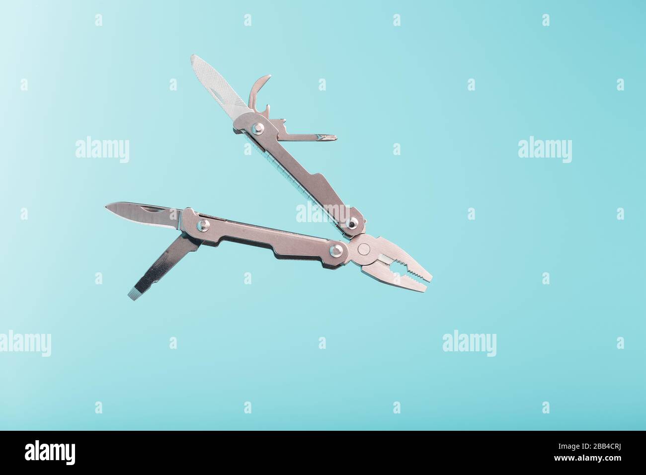 The multitool multi-function tool hovers on a blue background. The ...