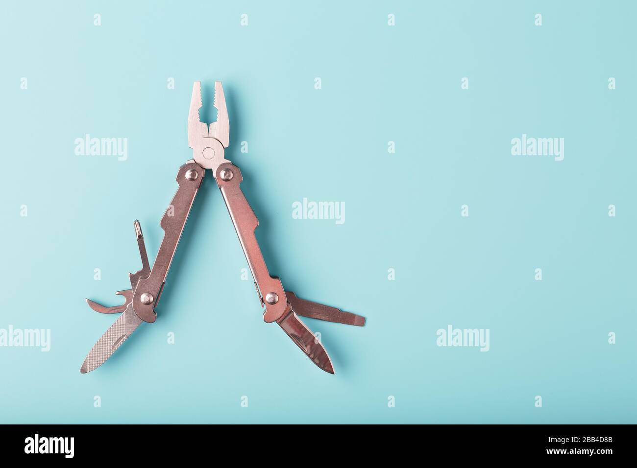 The multitool multi-function tool hovers on a blue background. The ...