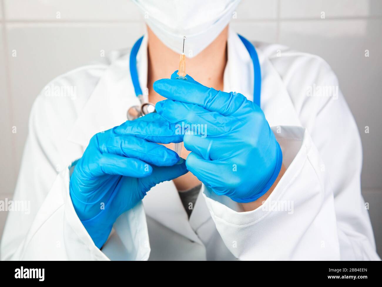 Close-up portrait of a healthcare professional preparing an injection ...