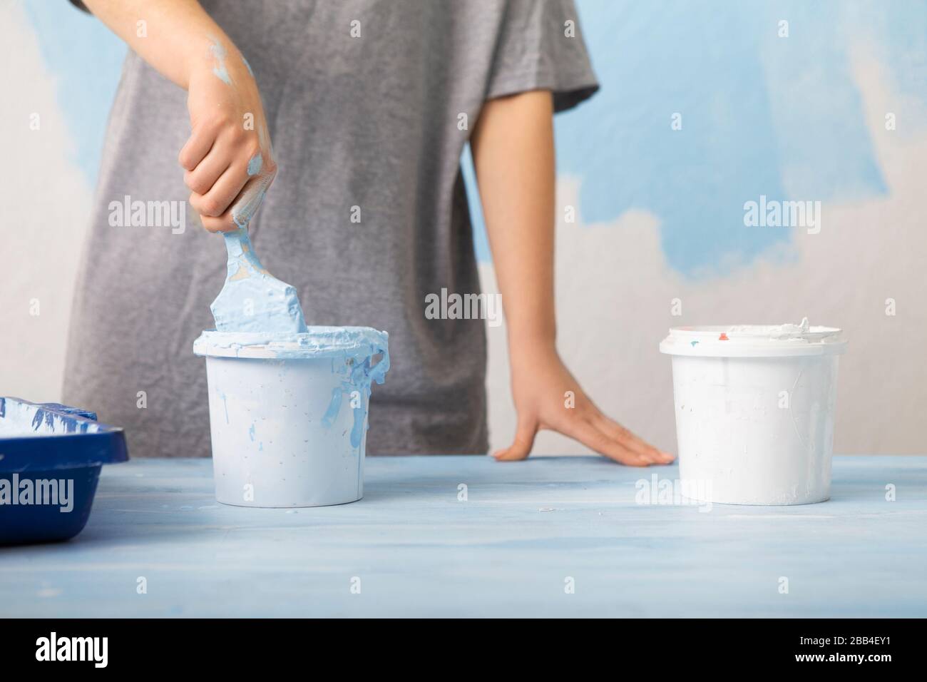 Woman mixing pigment and paint for wall painting Stock Photo - Alamy