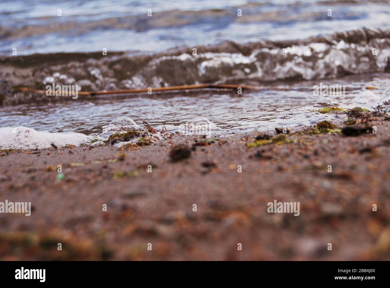 Details of rocks and sand on a Swedish lake with small waves Stock ...