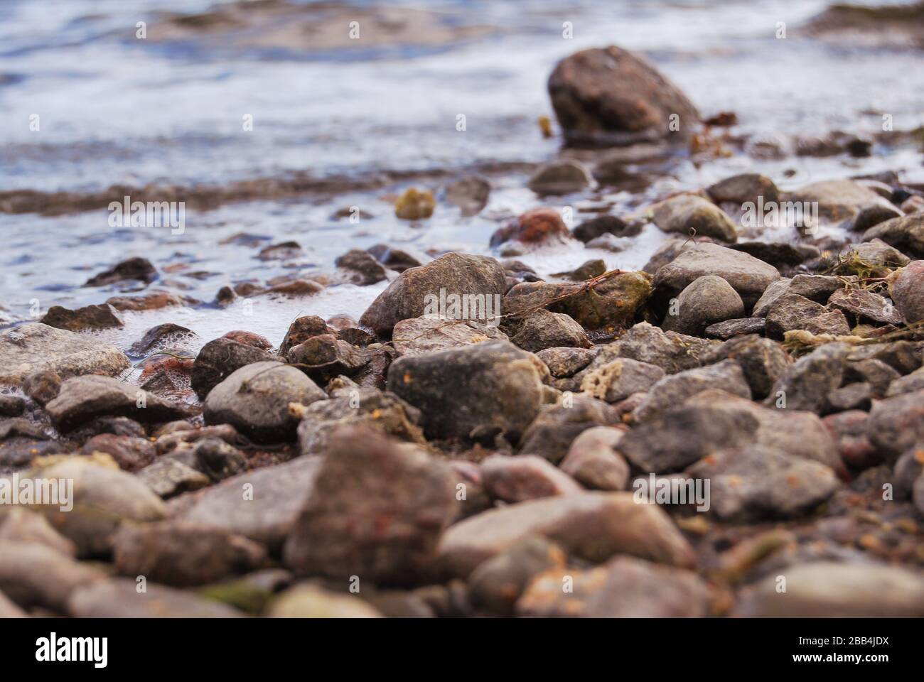 Details of rocks and sand on a Swedish lake with small waves Stock ...