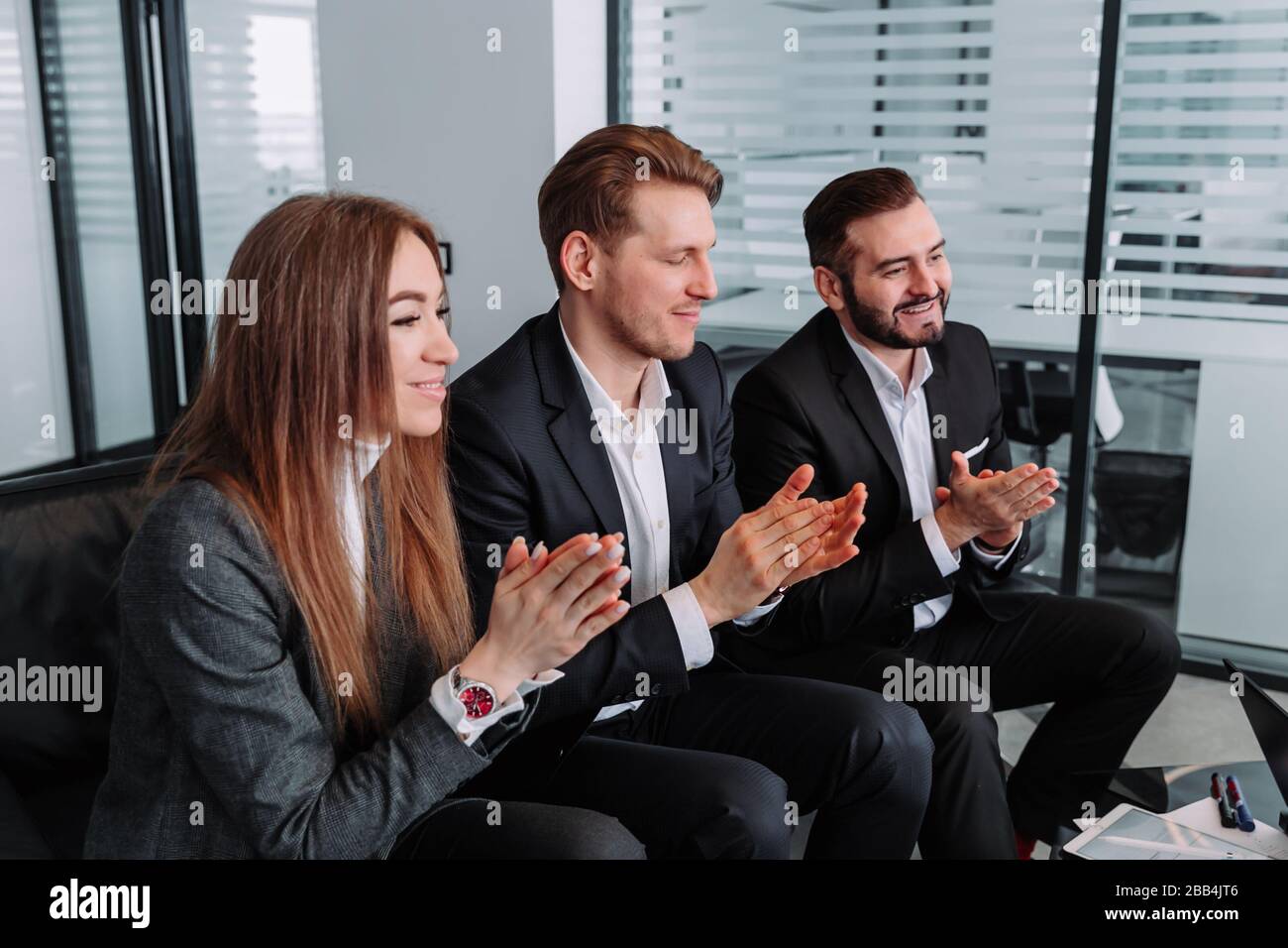 Great job Successful business team is clapping their hands in modern ...